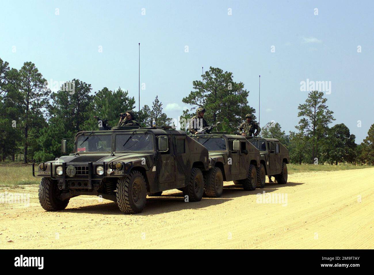 High-Mobility Multipurpose Wheeled Vehicles (HMMWV) are lined up while ...