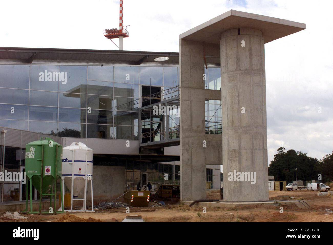 Medium long shot a new passenger terminal is under construction at ...
