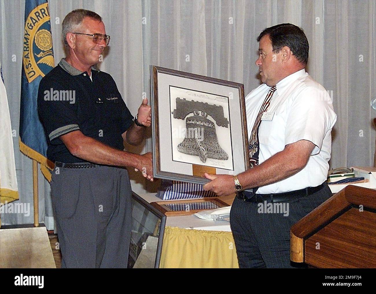 The posts first garrison manager Bruce Goldsborough accepts a picture ...