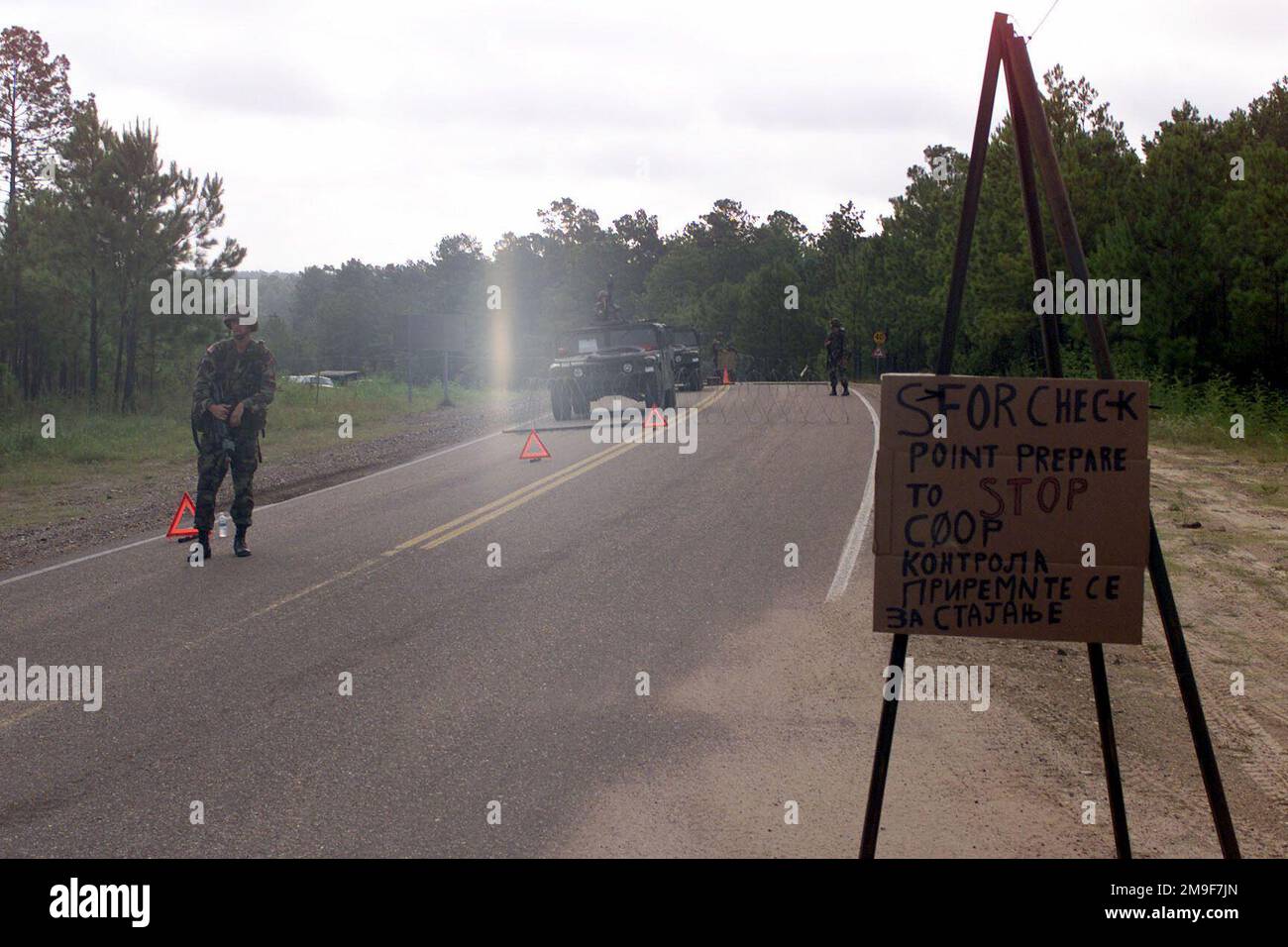 A security forces checkpoint, with High-Mobility Multipurpose Wheeled ...
