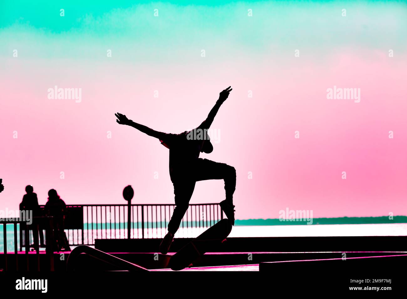 Unrecognizable teenage boy silhouette showing high jump tricks on ...