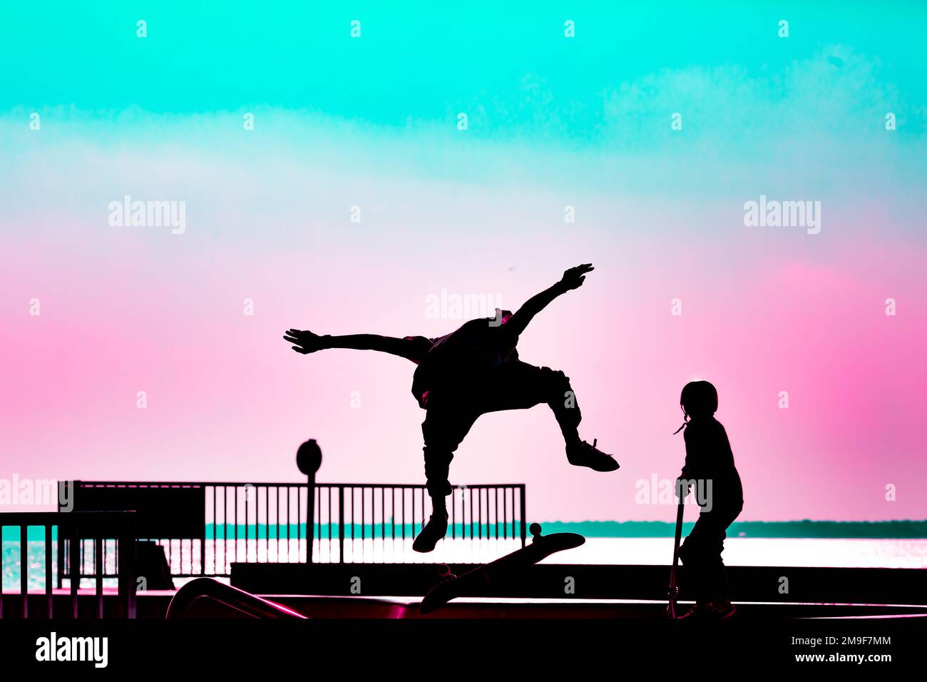 Unrecognizable teenage boy silhouette showing high jump tricks on ...