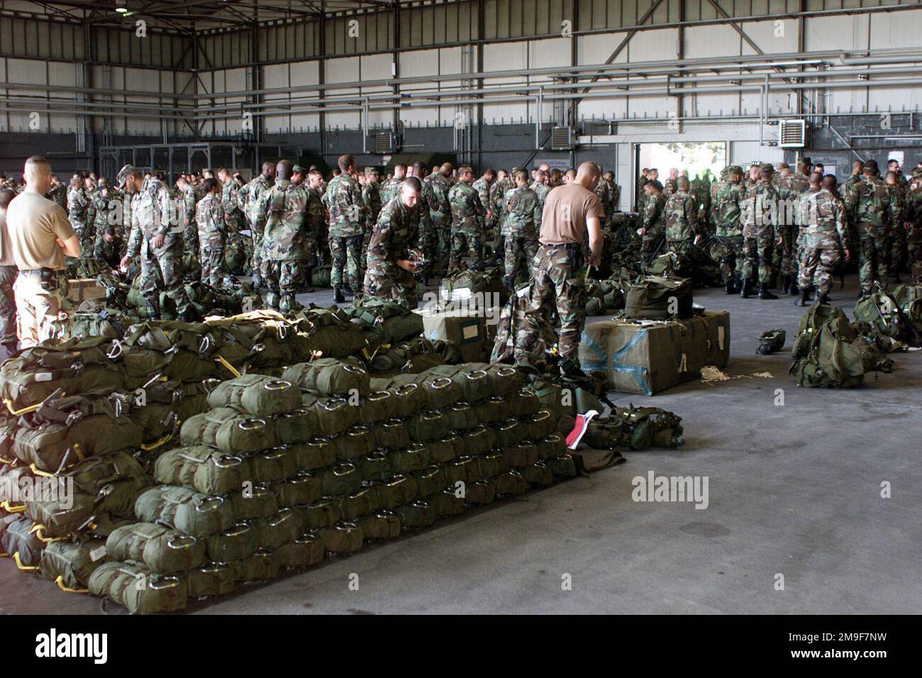 Straight on medium long shot from a high angle looking down as US Army ...