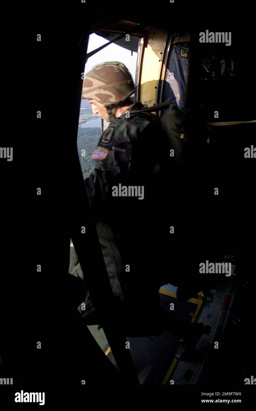 Left side rear view medium shot as US Army troops from the 1ST of the ...