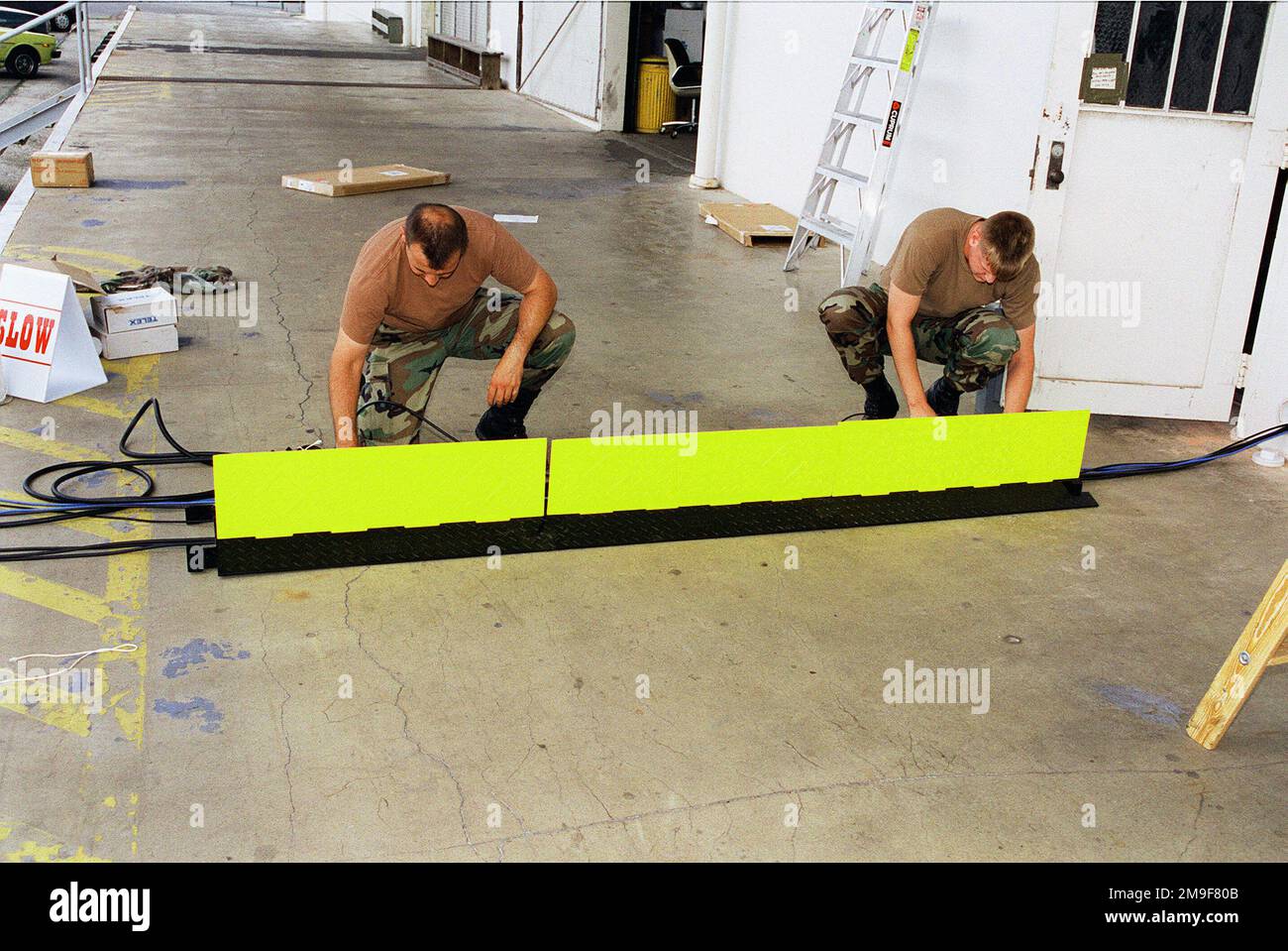US Army Sergeant Day (Left) and SPECIALIST Kruman arrange cable in a ...