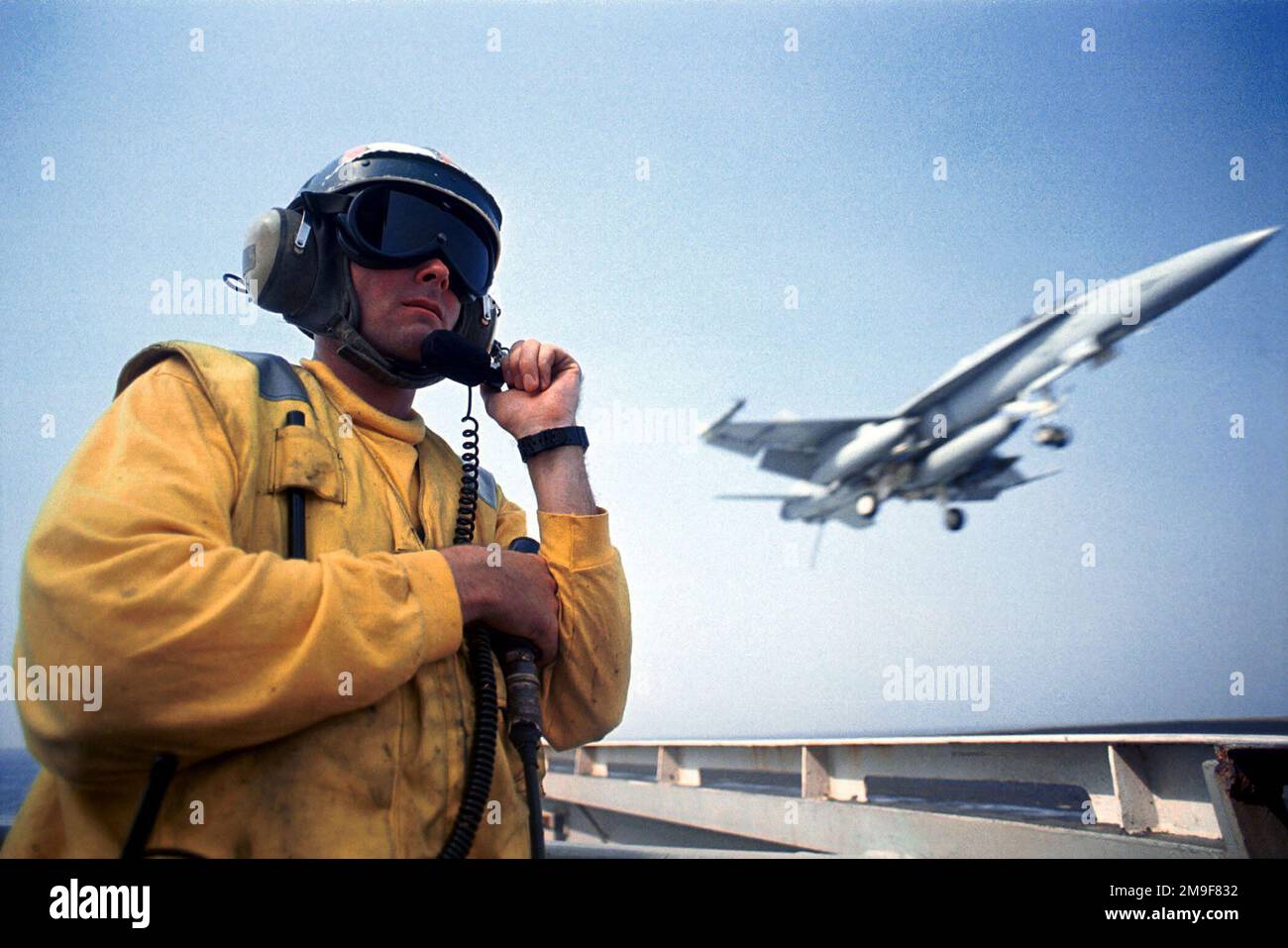 Lieutenant Commander Donald Eby ensures the arresting cables are ready ...