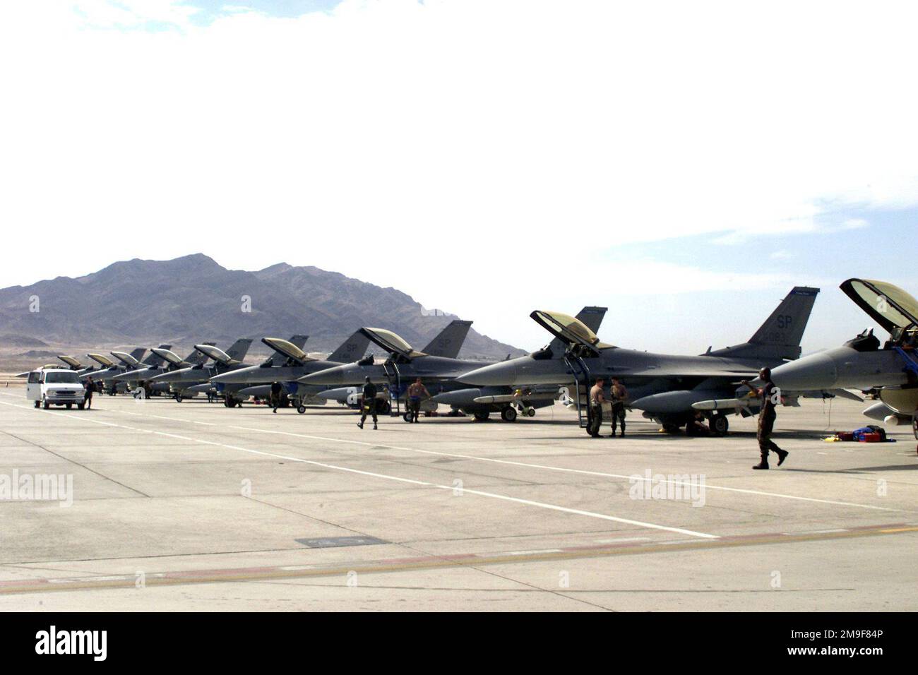 Medium long shot, left front view, row of ten F-16C Fighting Falcons ...