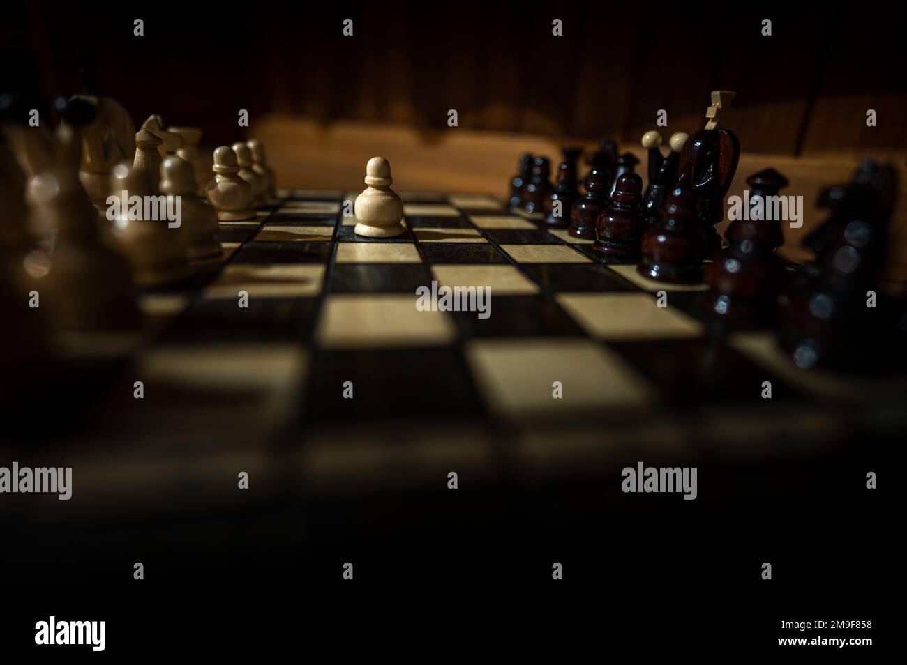 Blurred background with a low depth of focus. The set of wooden chess ...