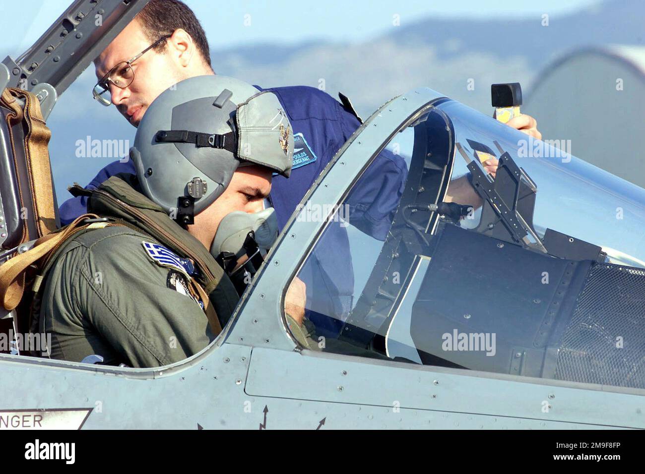 Left side profile medium close-up shot as Greek Air Force STAFF Sergeant John Papadopoulos ...