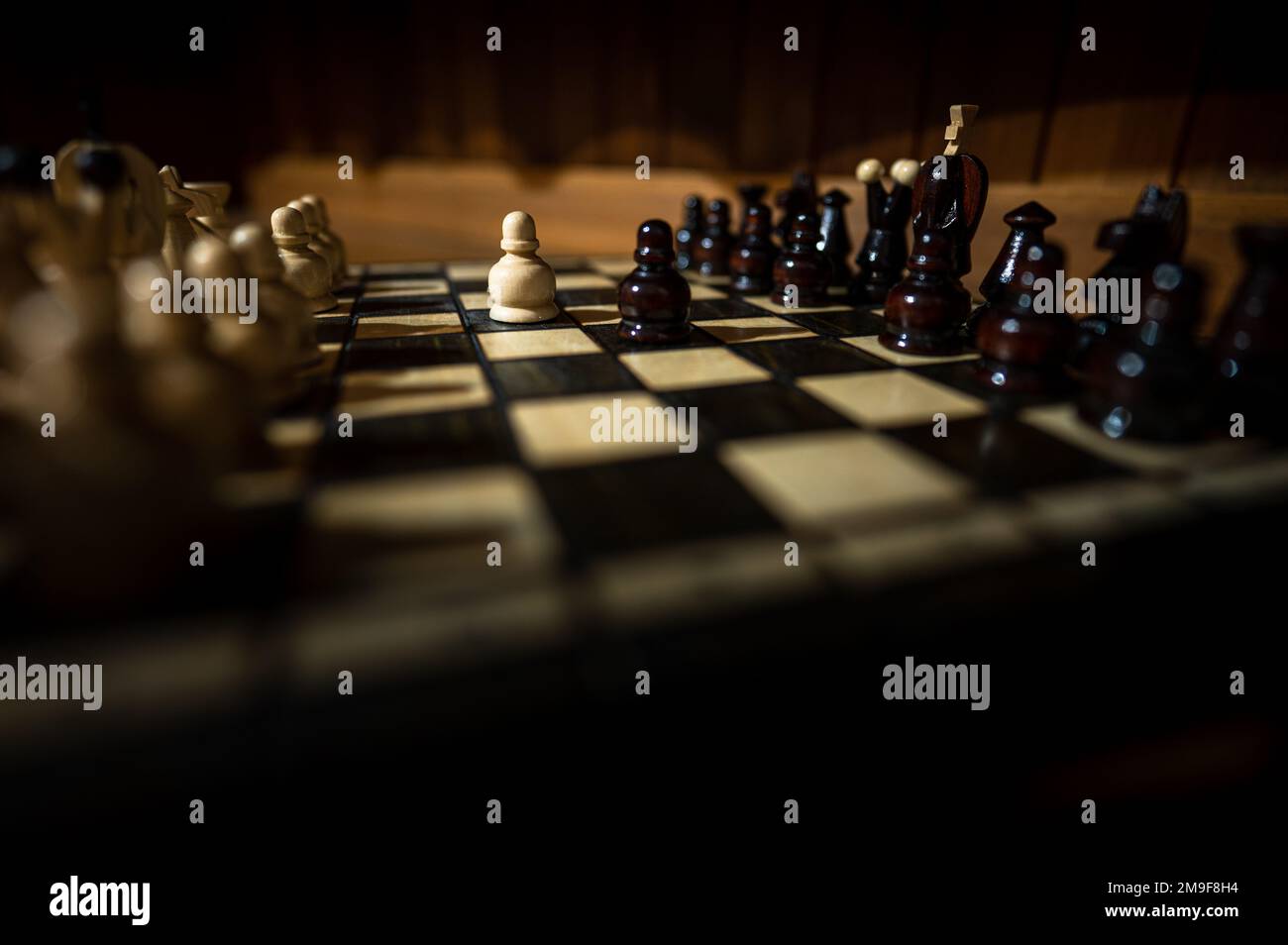 Blurred background with a low depth of focus. The set of wooden chess ...
