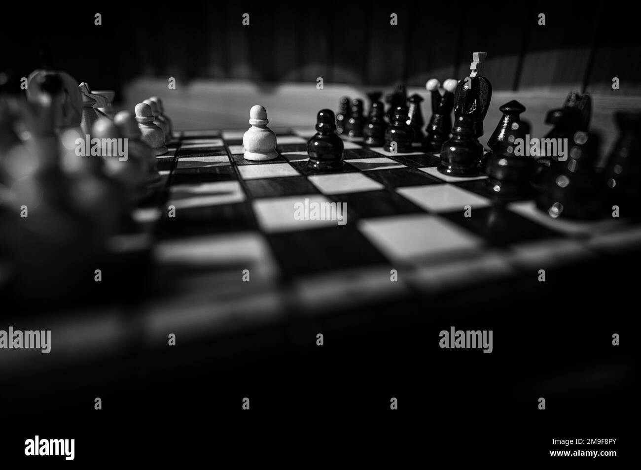 The set of wooden chess pieces elements standing on chess board on dark ...