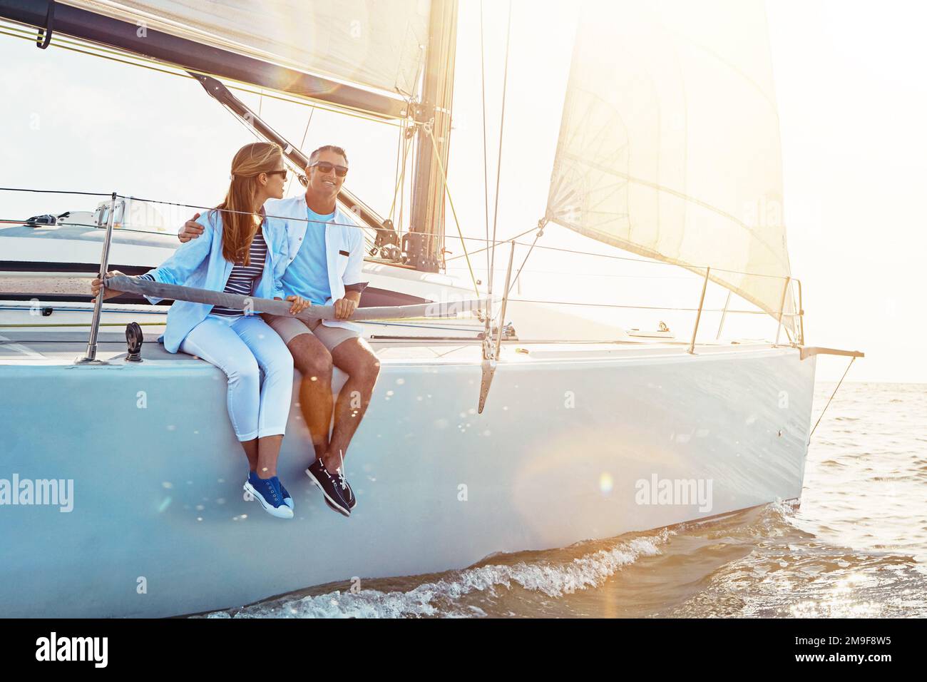 Couple, yacht cruise and relax on ocean for sunset travel holiday ...