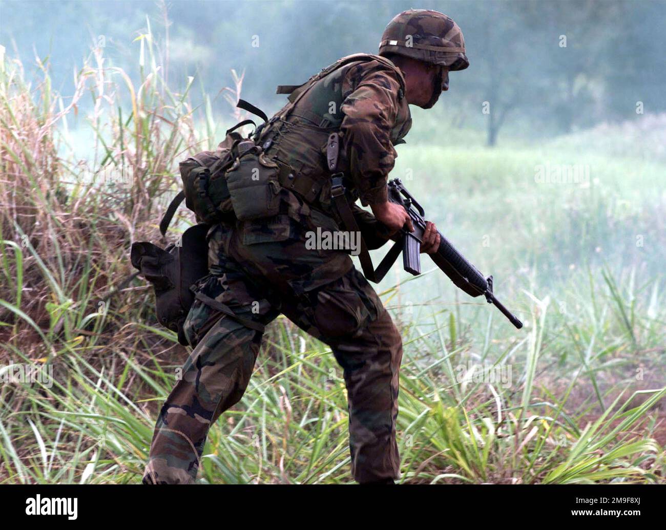 A US Marine, from 1ST Battalion, 3rd Marine Bravo Company, armed with ...