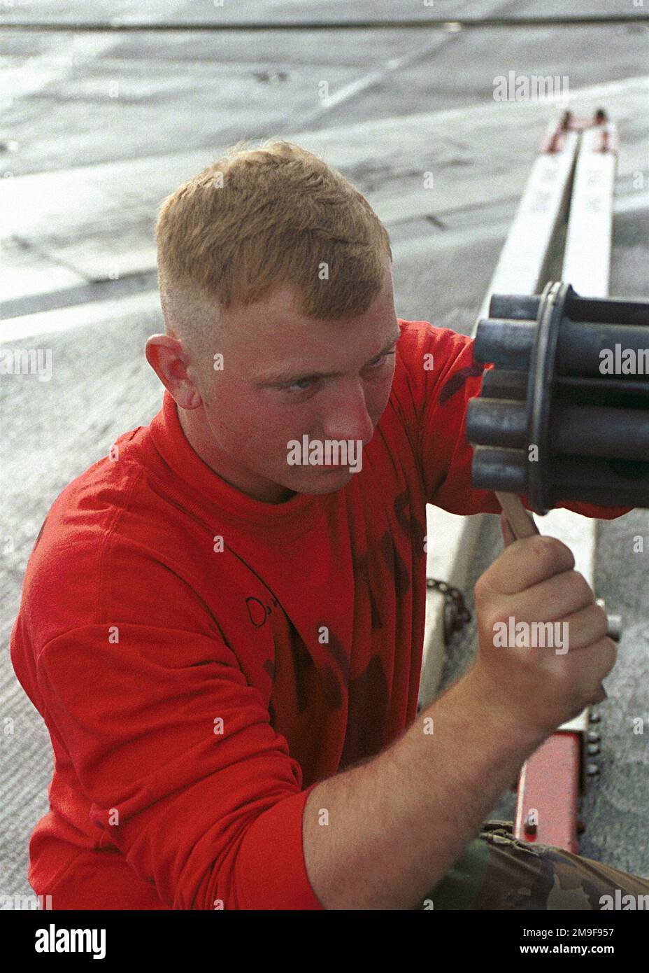 US Navy Aviation Ordnanceman Third Class David Dowling cleans the ...
