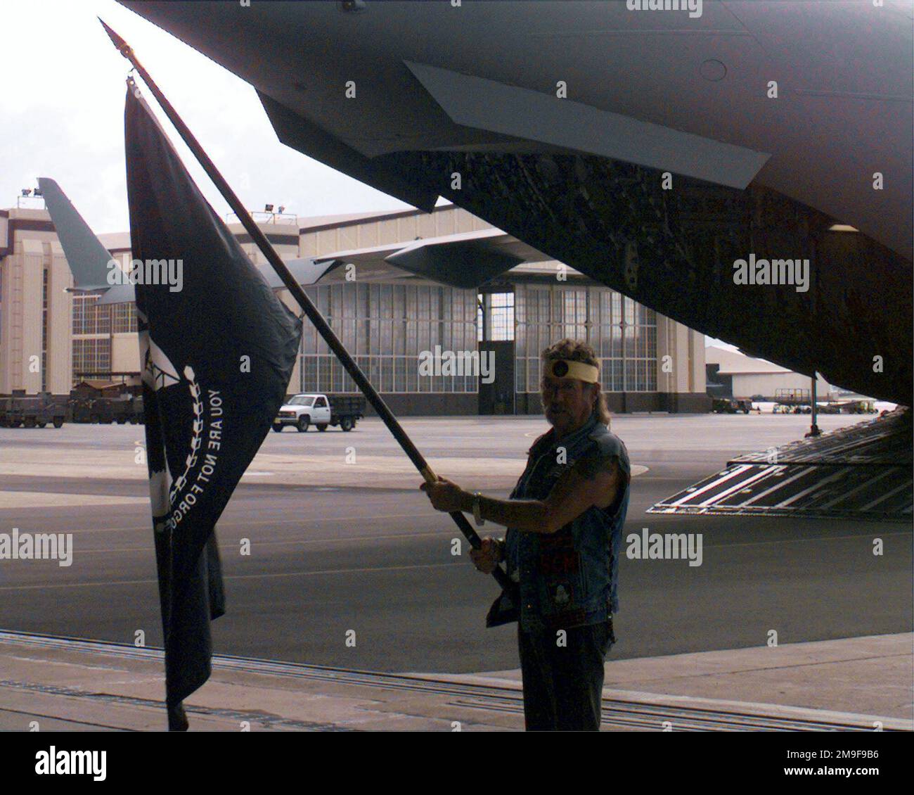 A Vietnam Veteran lets the MIA/POW flag wave beside the rear entrance ...