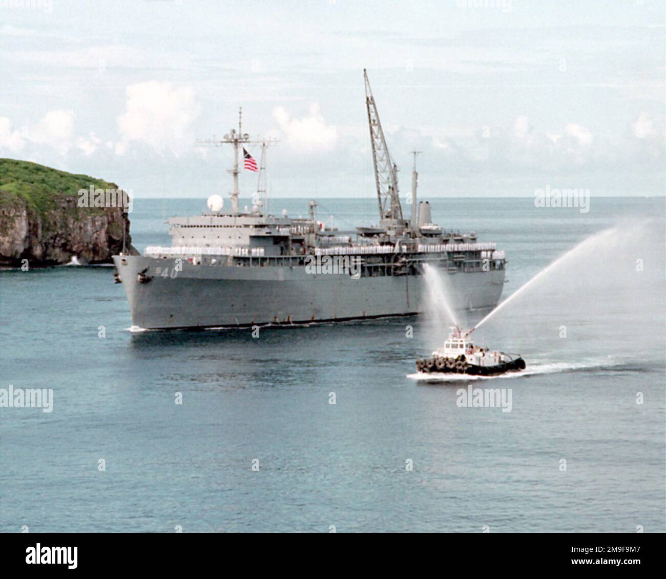 A port bow view of the submarine tender USS FRANK CABLE (AS 40 ...