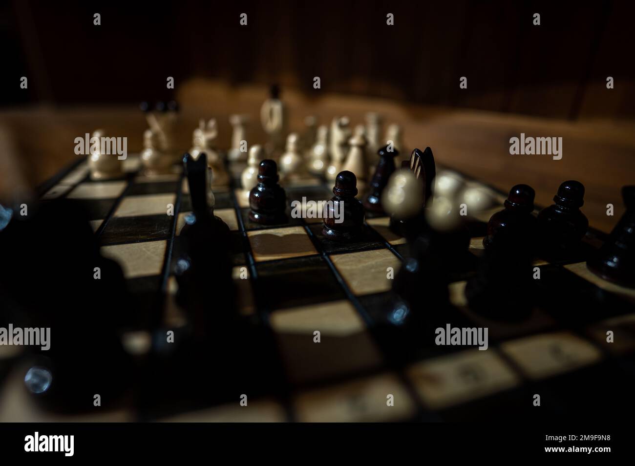Blurred background with a low depth of focus. The set of wooden chess ...