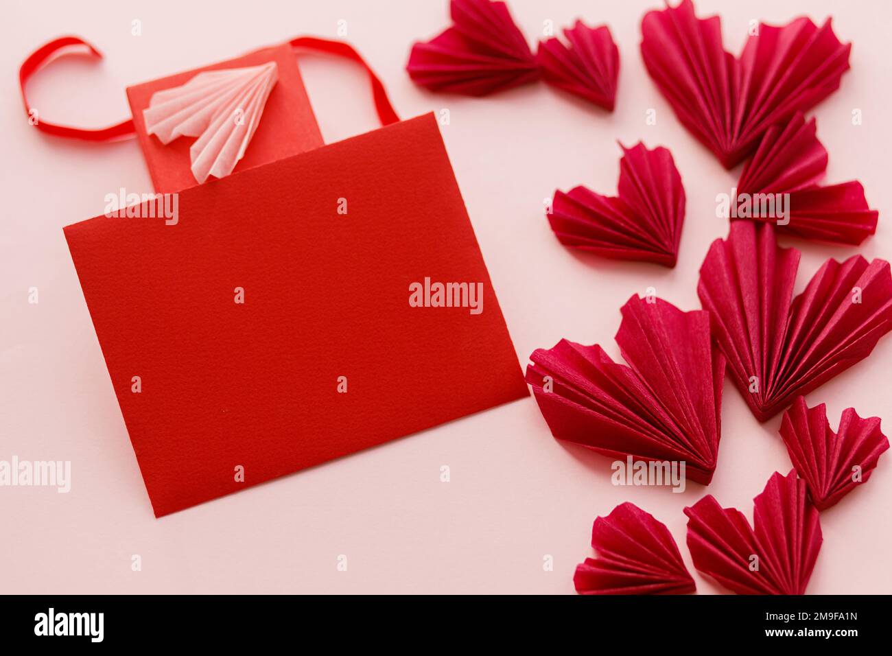 Happy Valentine's day! Empty red card and stylish pink hearts on pink ...