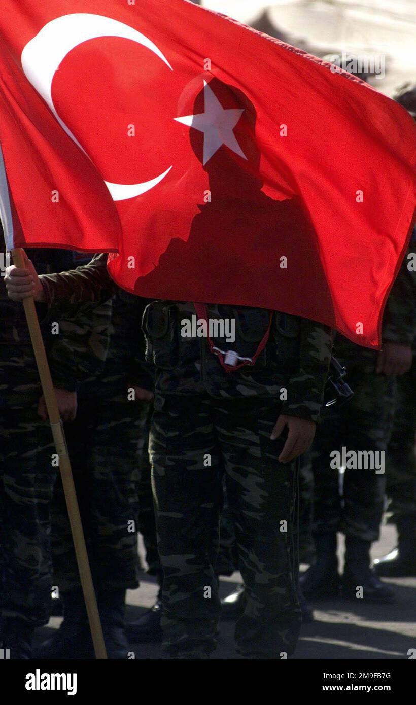 A Turkish soldier holds his country's flag during the opening ...