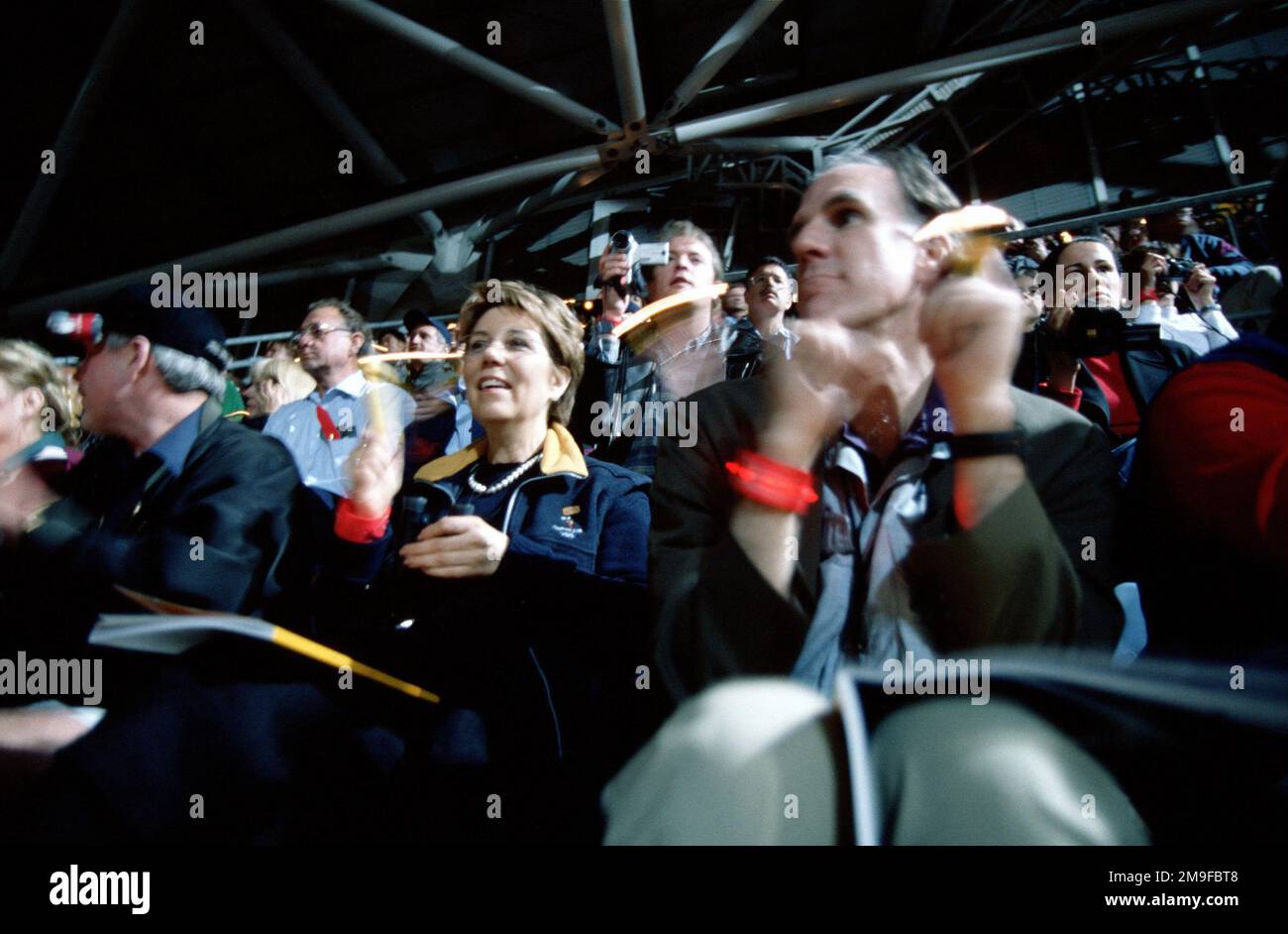 Some of the 110,000 members of the audience take part in the ...