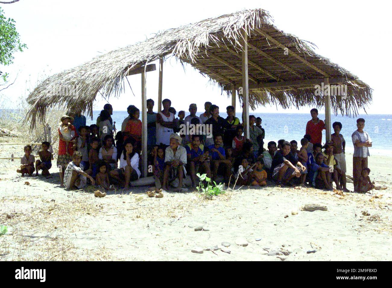 The local people watch excitedly as a Landing Craft Air Cushion (LCAC ...