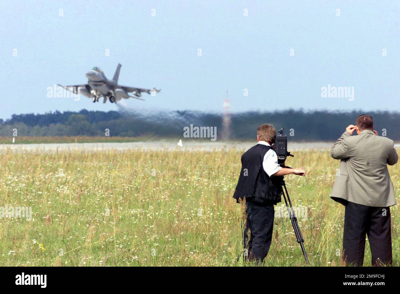 Members of a Slovakian news agency film an F-16 Fighting Falcon ...
