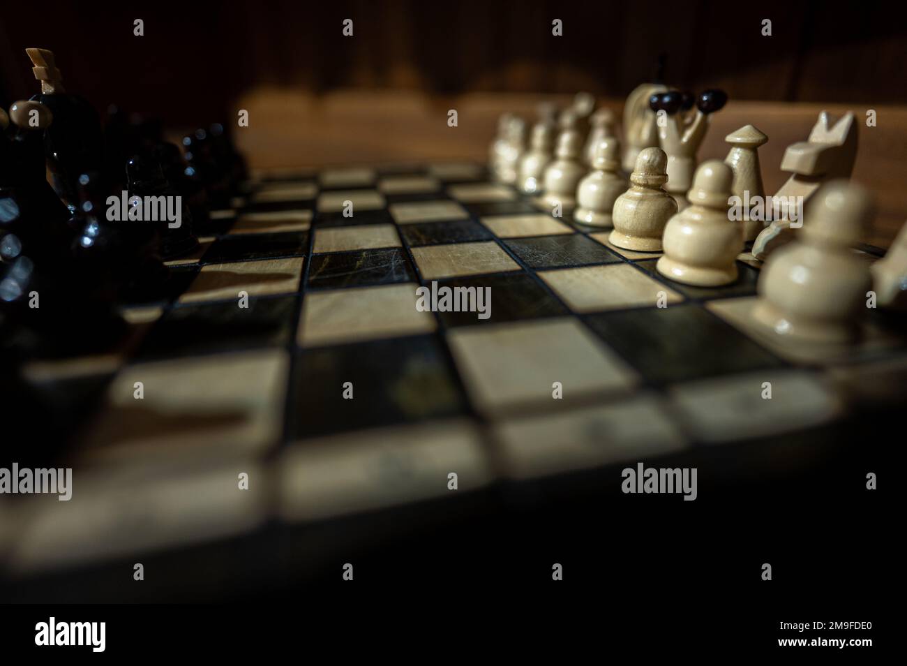 Blurred background with a low depth of focus. The set of wooden chess ...
