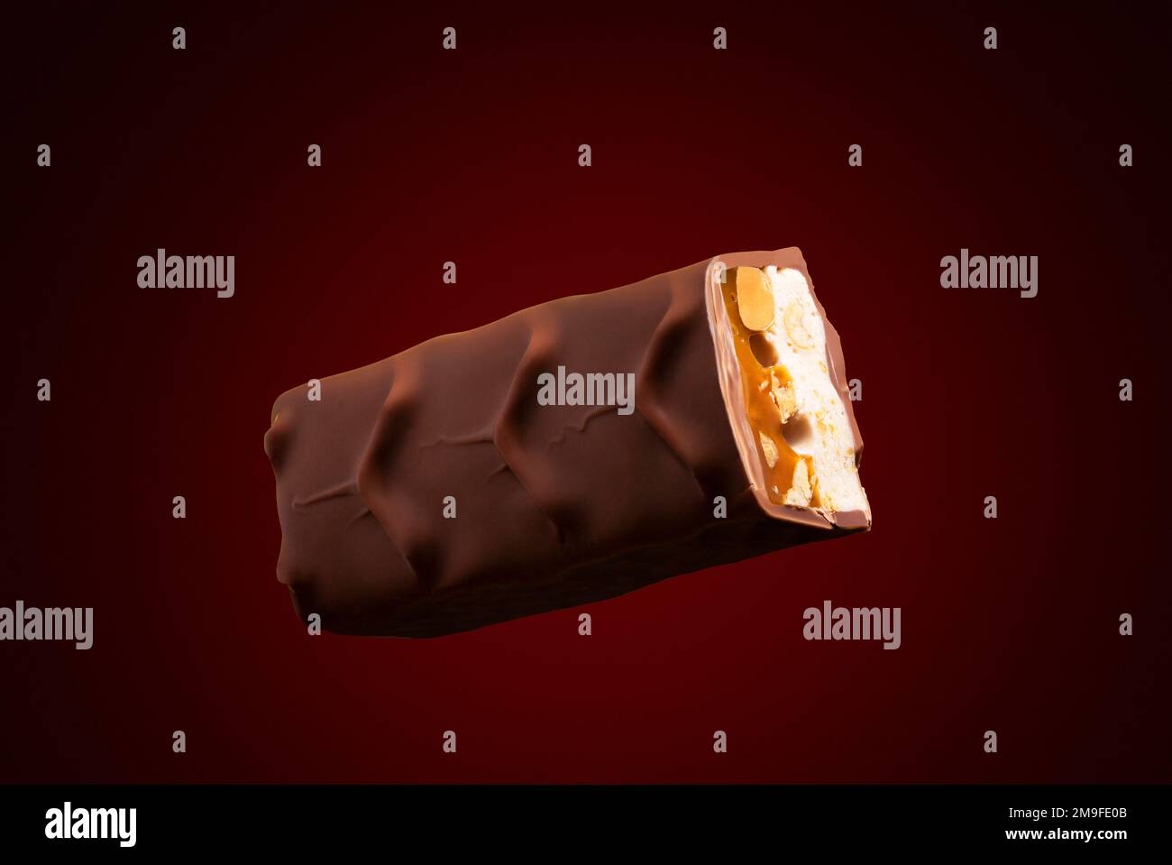 Levitating candy bar on a dark background. Clipping path. Full depth of ...