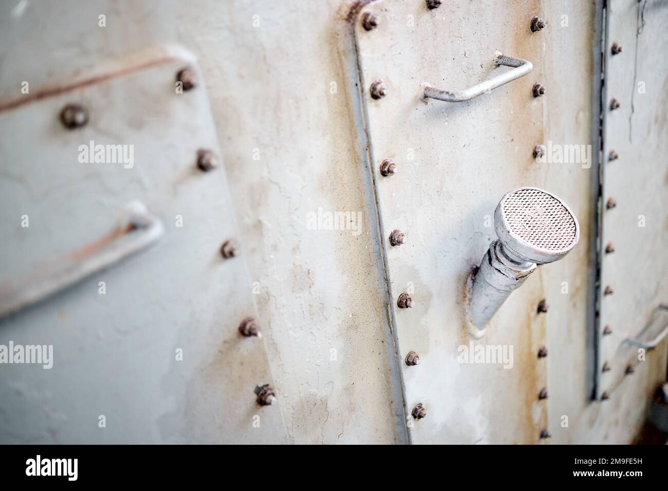 Three metal hatches plates on compressor for revision close-up with oil ...