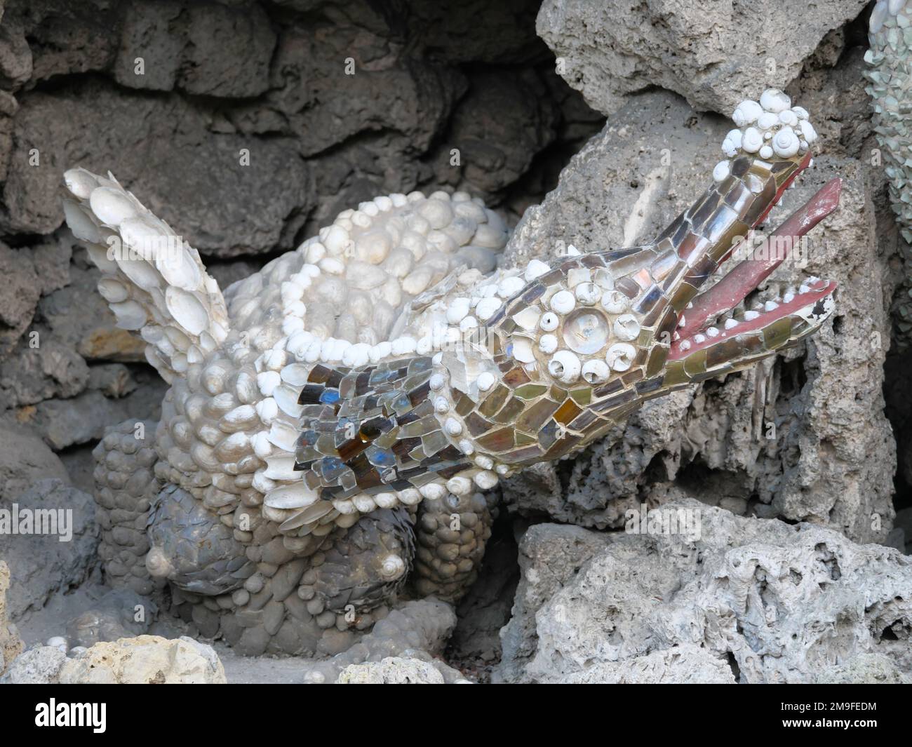Dragon head formed from shells and snails on baroque garden house Stock ...
