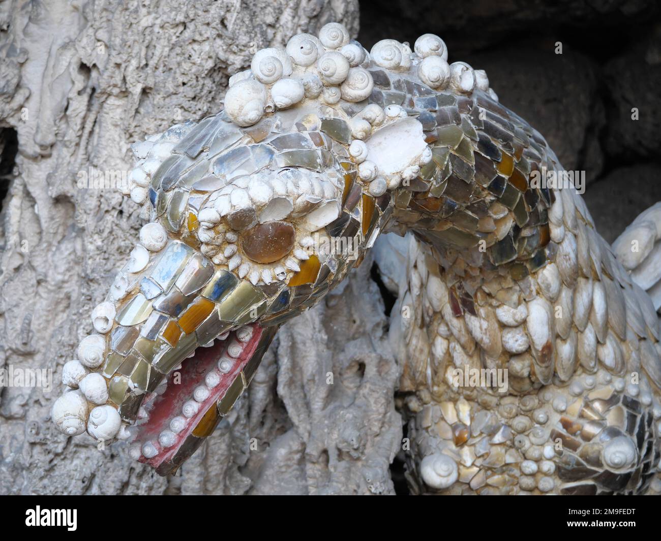Dragon head formed from shells and snails on baroque garden house Stock ...