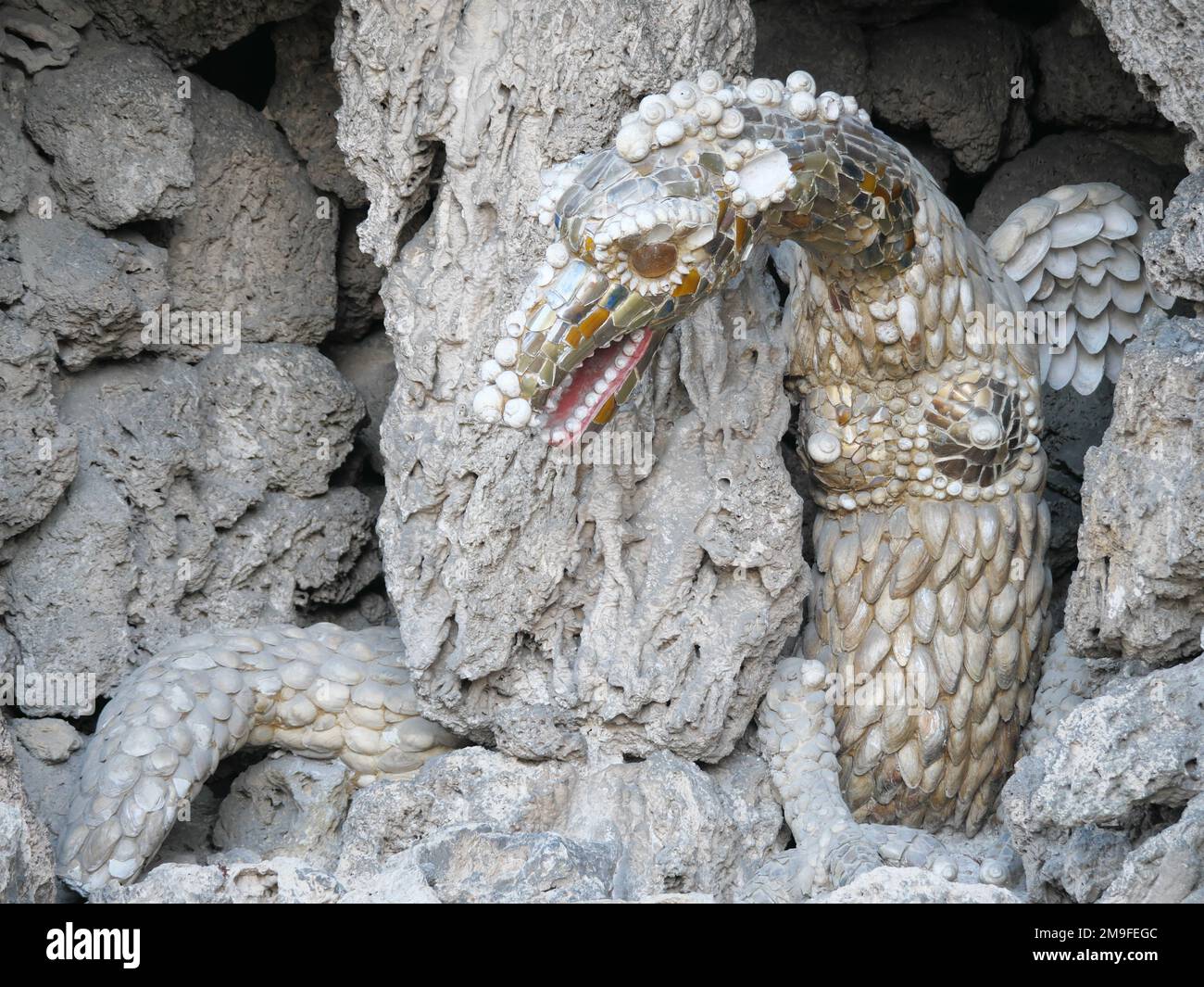 Dragon head formed from shells and snails on baroque garden house Stock ...