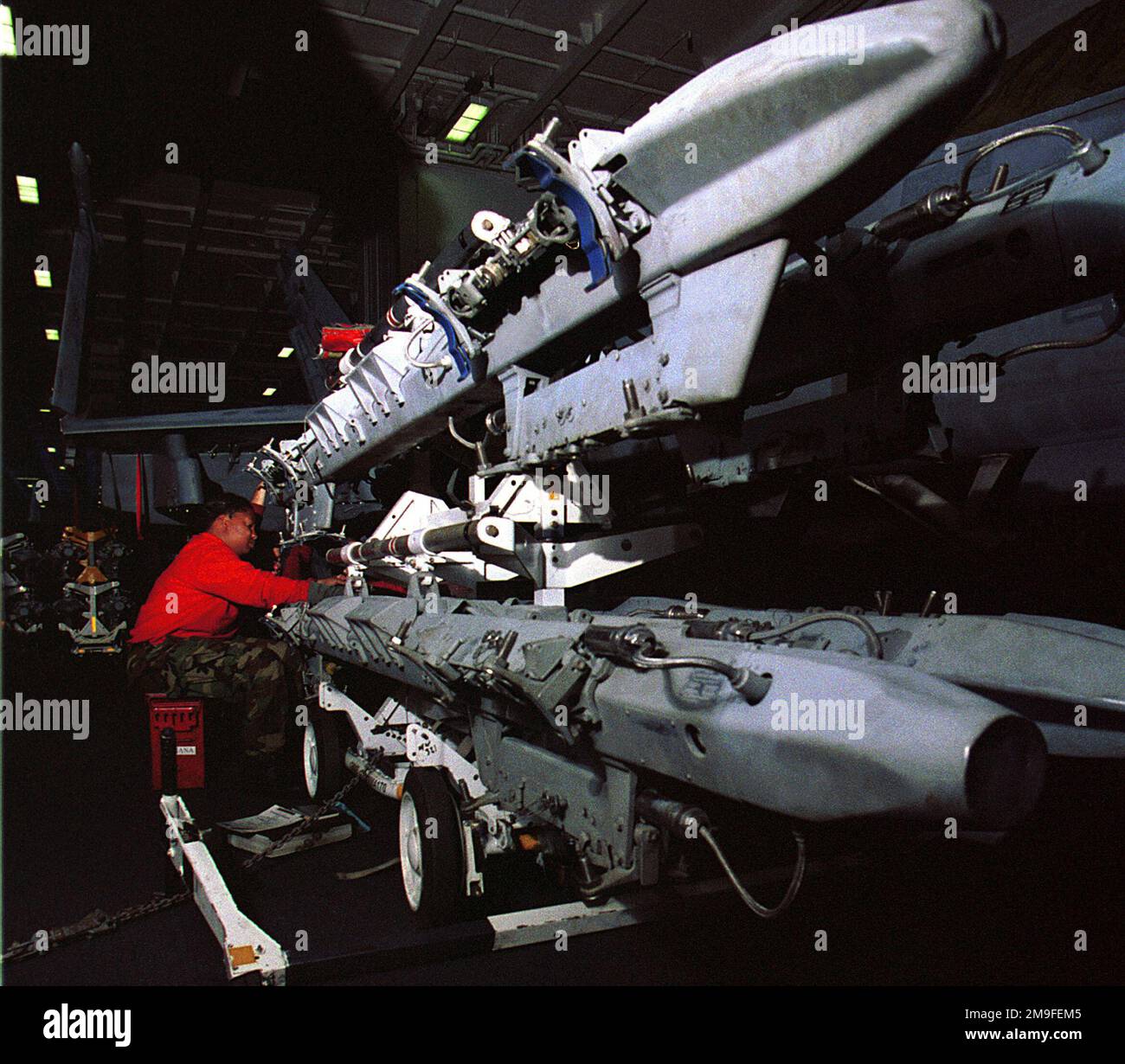 US Navy Aviation Ordnanceman Laura Buffin performs maintenance on an ...