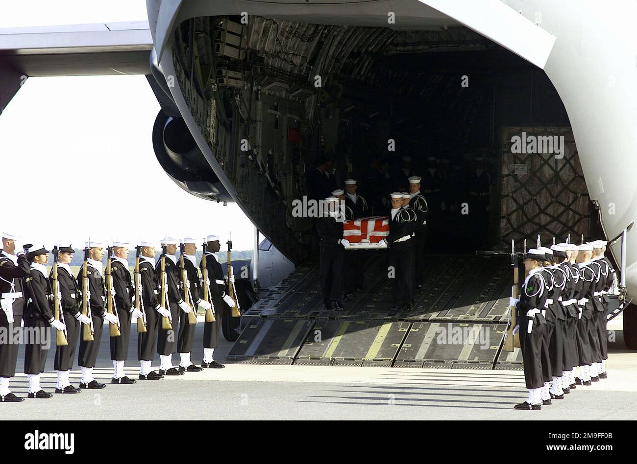 Members of the United States Navy Ceremonial Guard remove the casket of ...