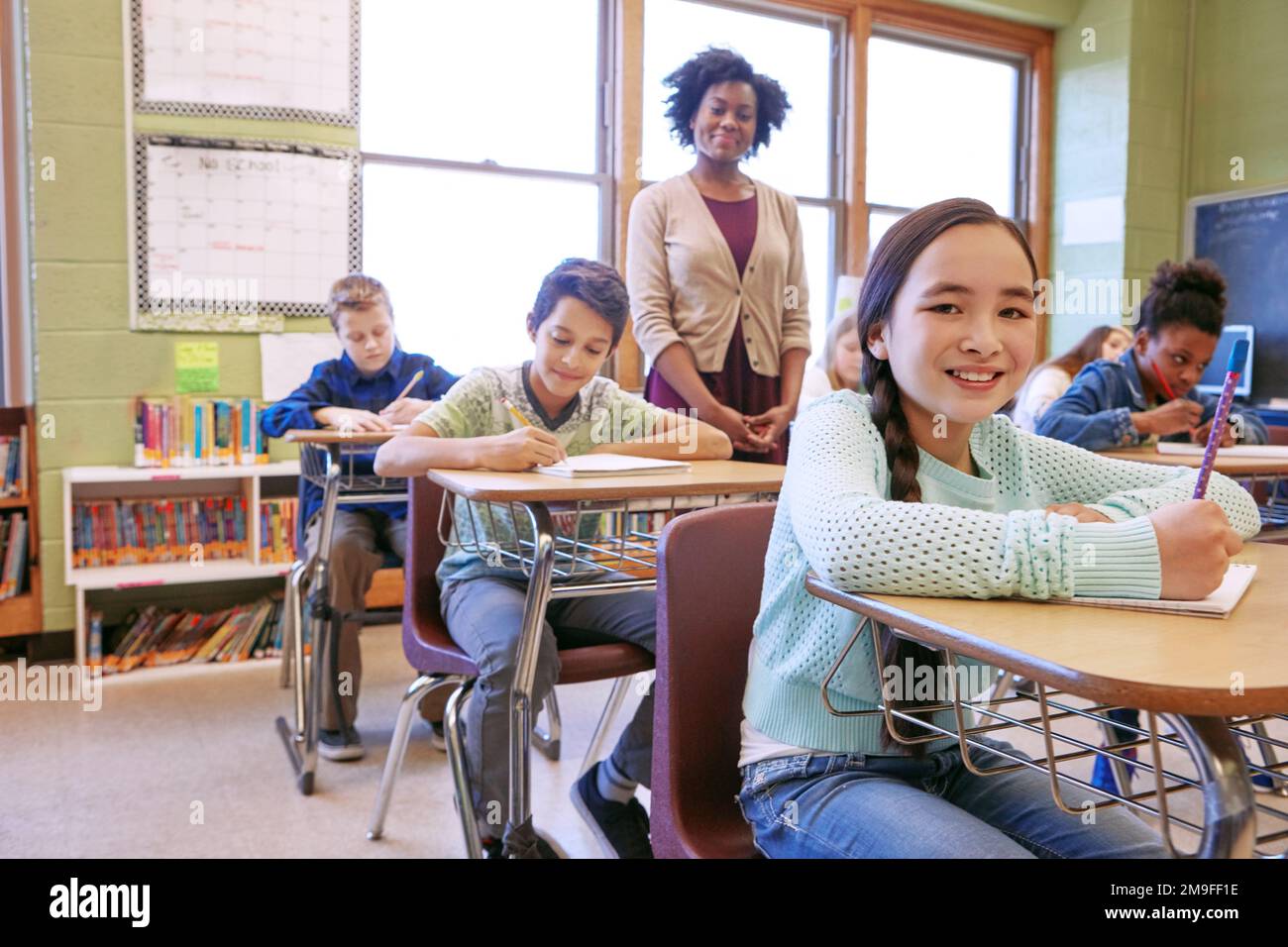 Learning, teacher and portrait of a girl with a smile to study, writing ...