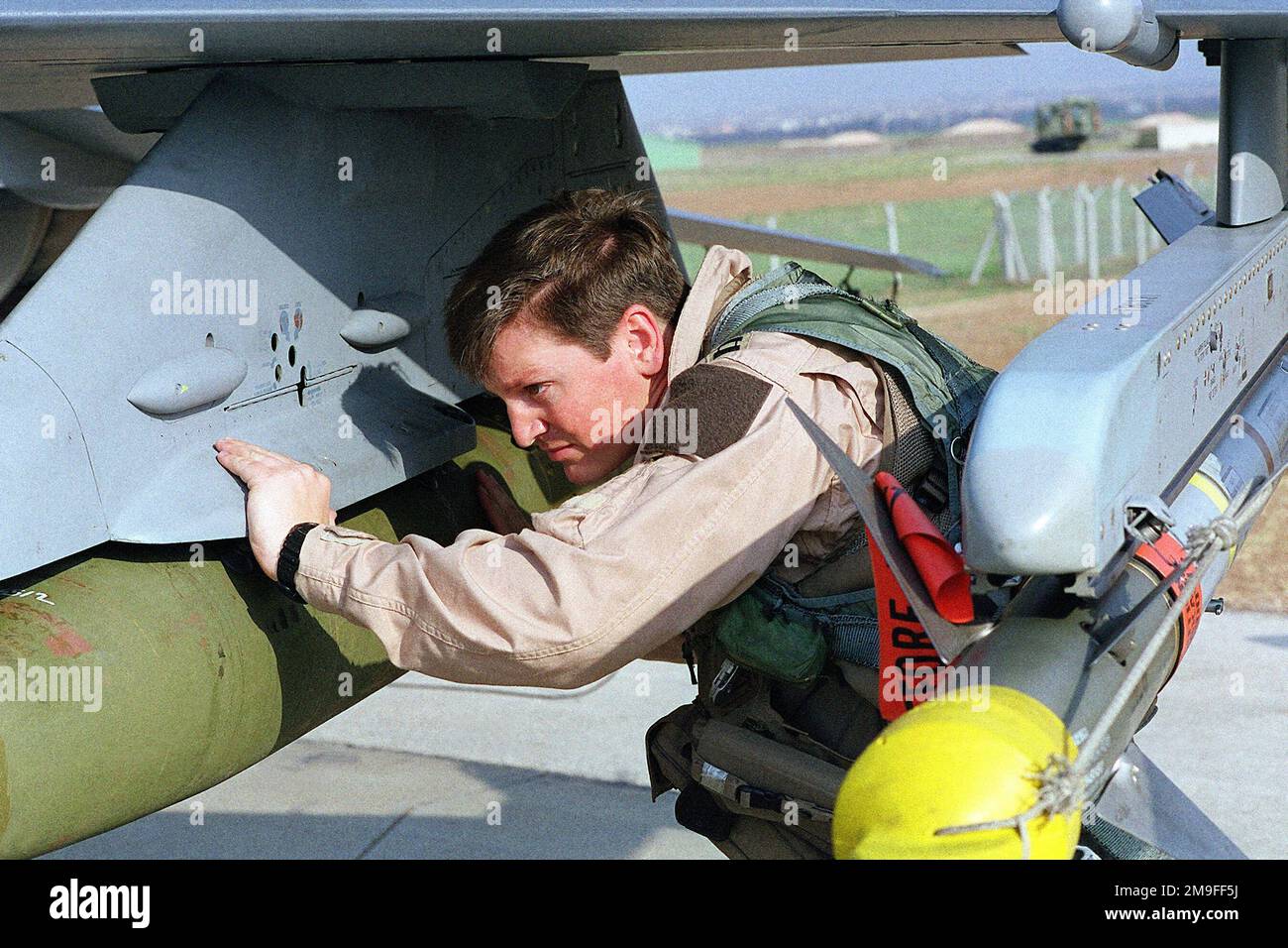 US Air Force Captain Christopher Snider preforms a preflight ordnance ...