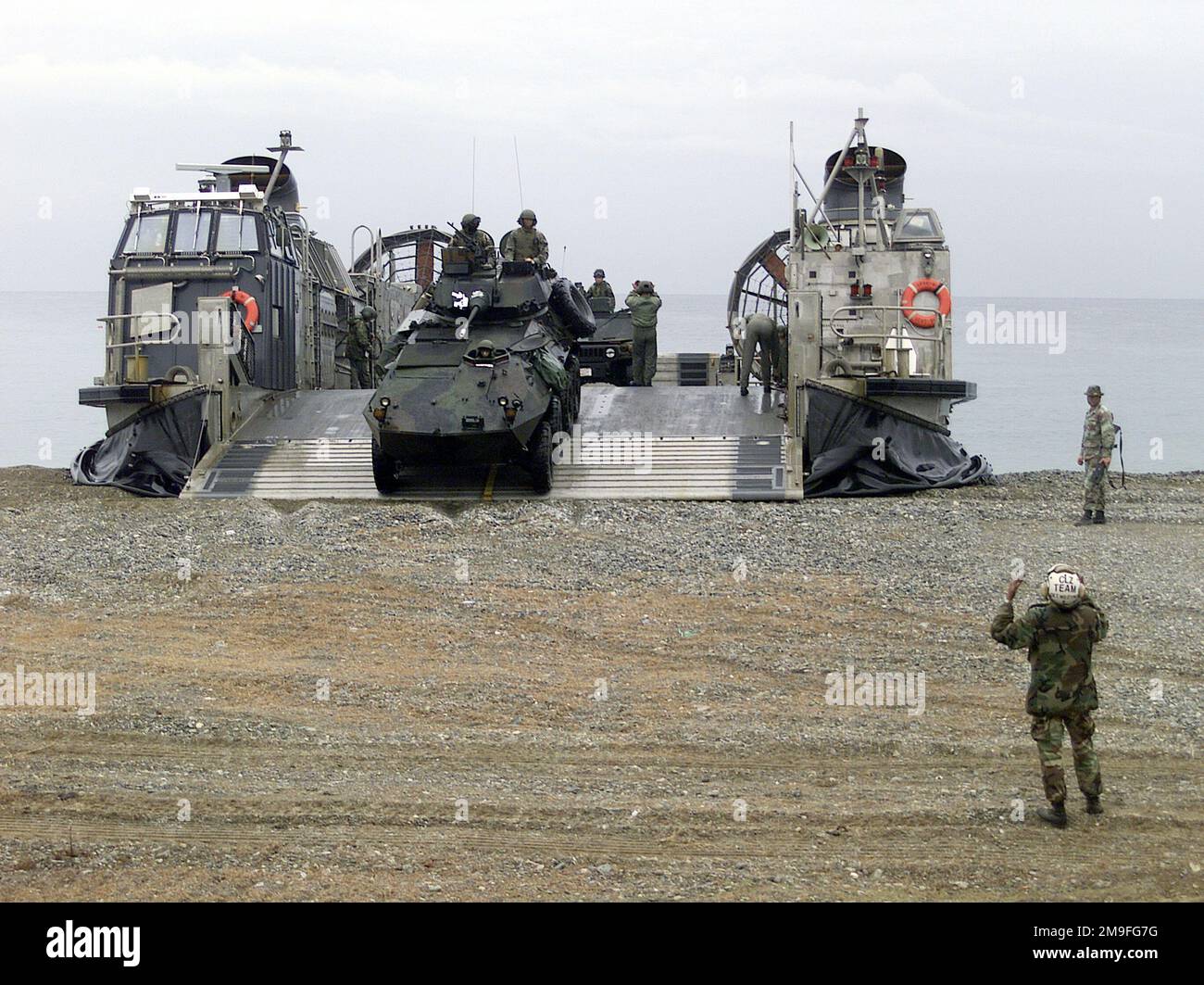 A US NAVY Landing Craft Air Cushion (LCAC), off loads Light Armored ...