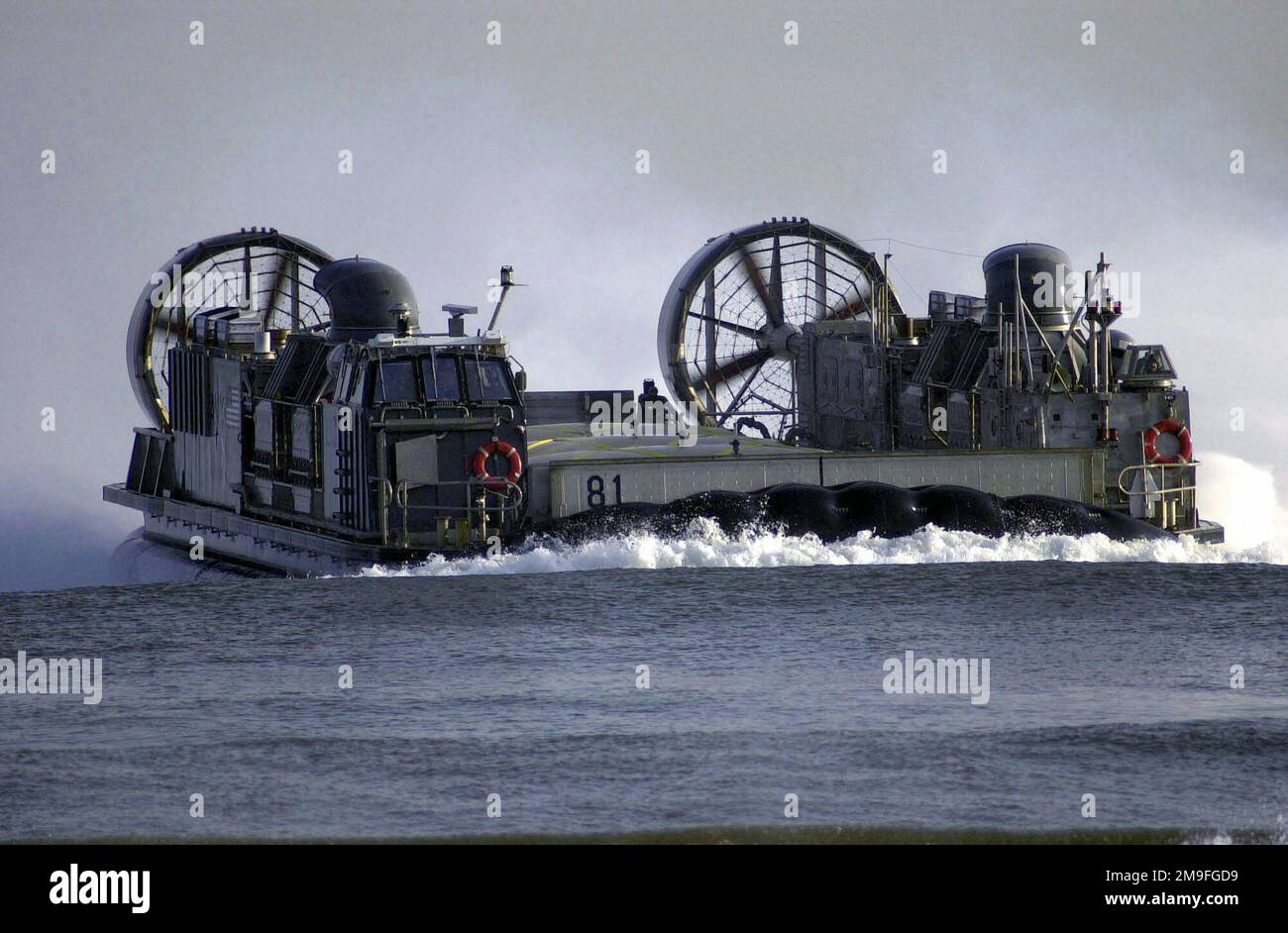 A Landing Craft, Air Cushioned (LCAC) glides onto Dogu beach from the ...