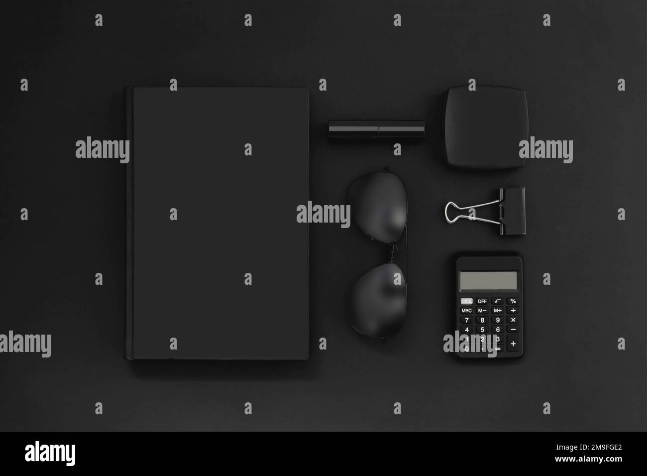 Collection of office accessories in black on black. Creative monochrome ...