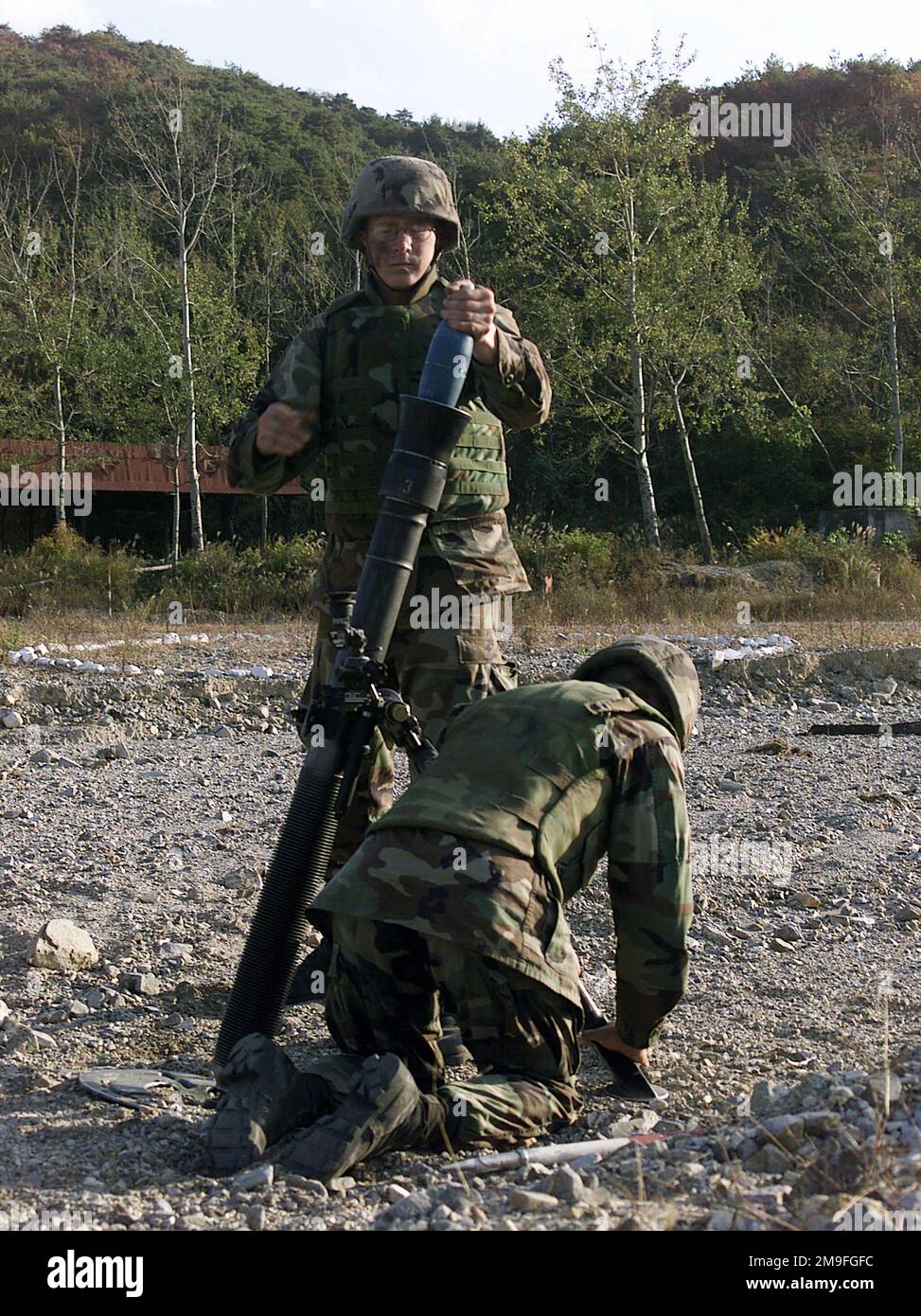 US Marine Corps LCPL Smith drops a round into the 81mm M252 Mortar at ...