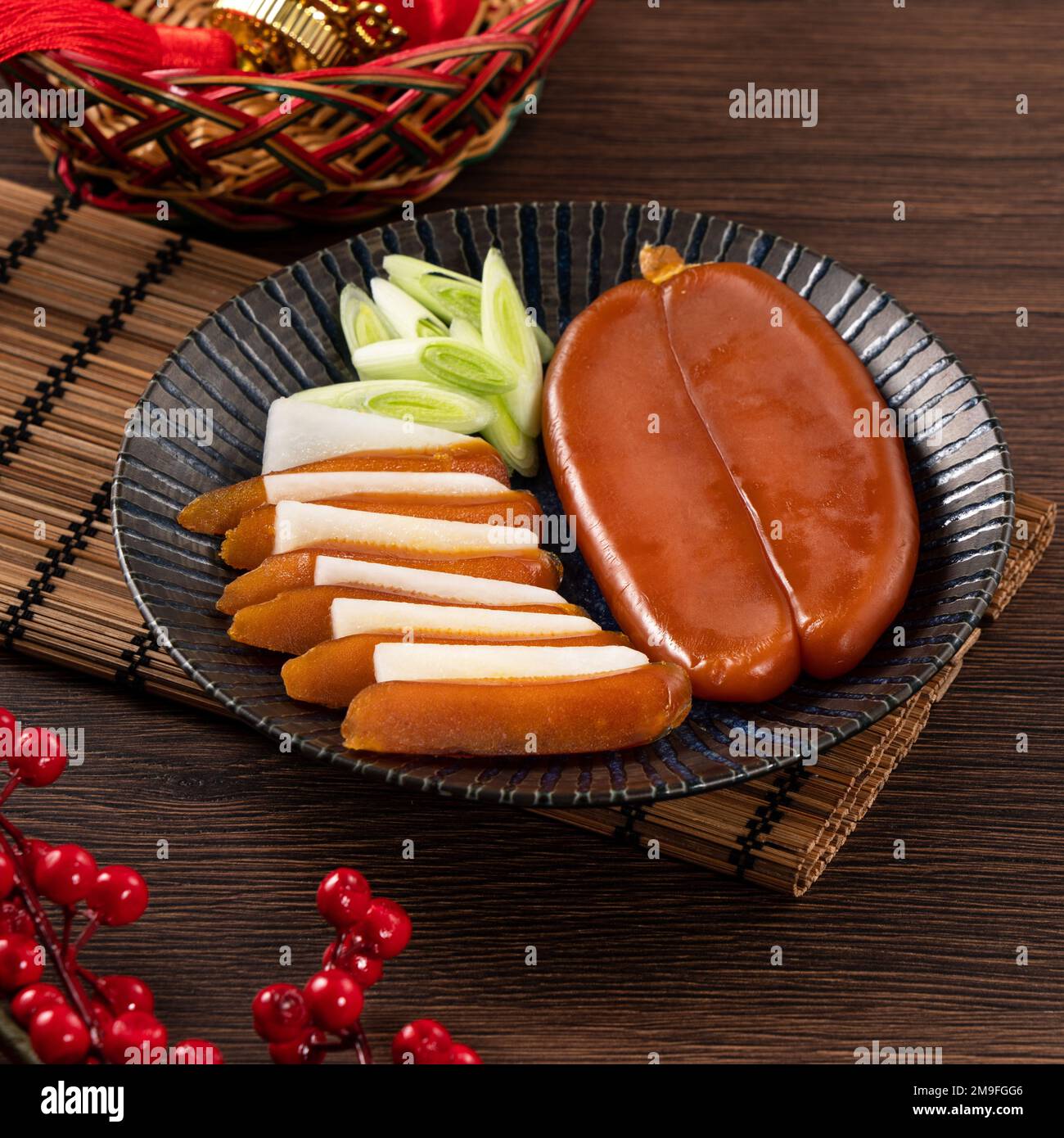 Delicious fresh mullet roe with white radish slices and garlic sprout ...