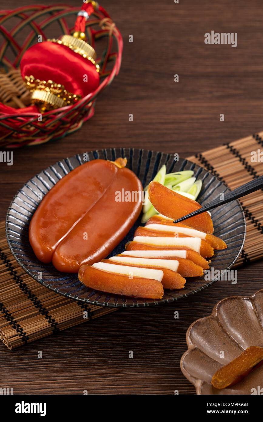 Delicious fresh mullet roe with white radish slices and garlic sprout ...