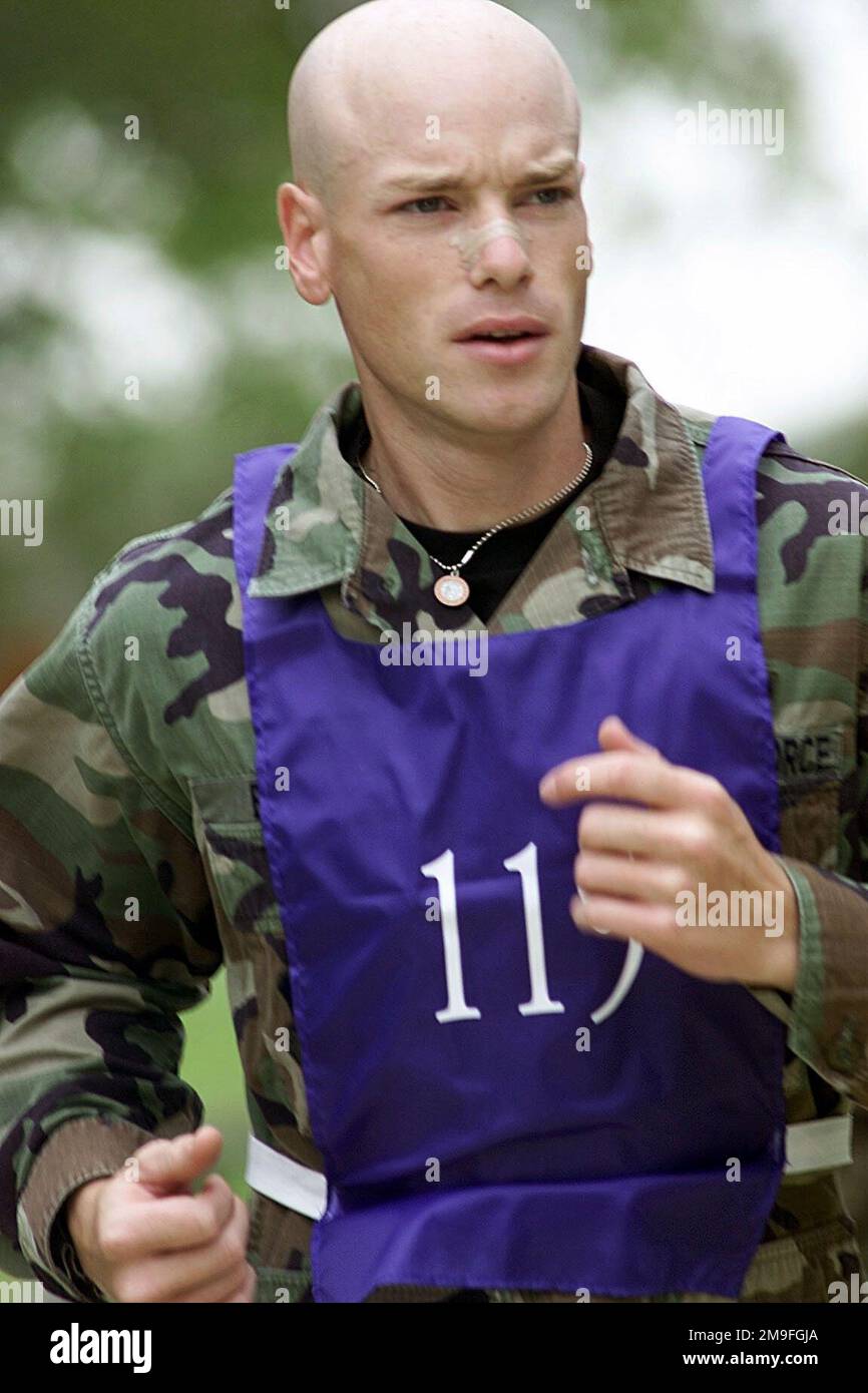 US Air Force STAFF Sergeant Jason Bren runs toward the next obstacle of ...