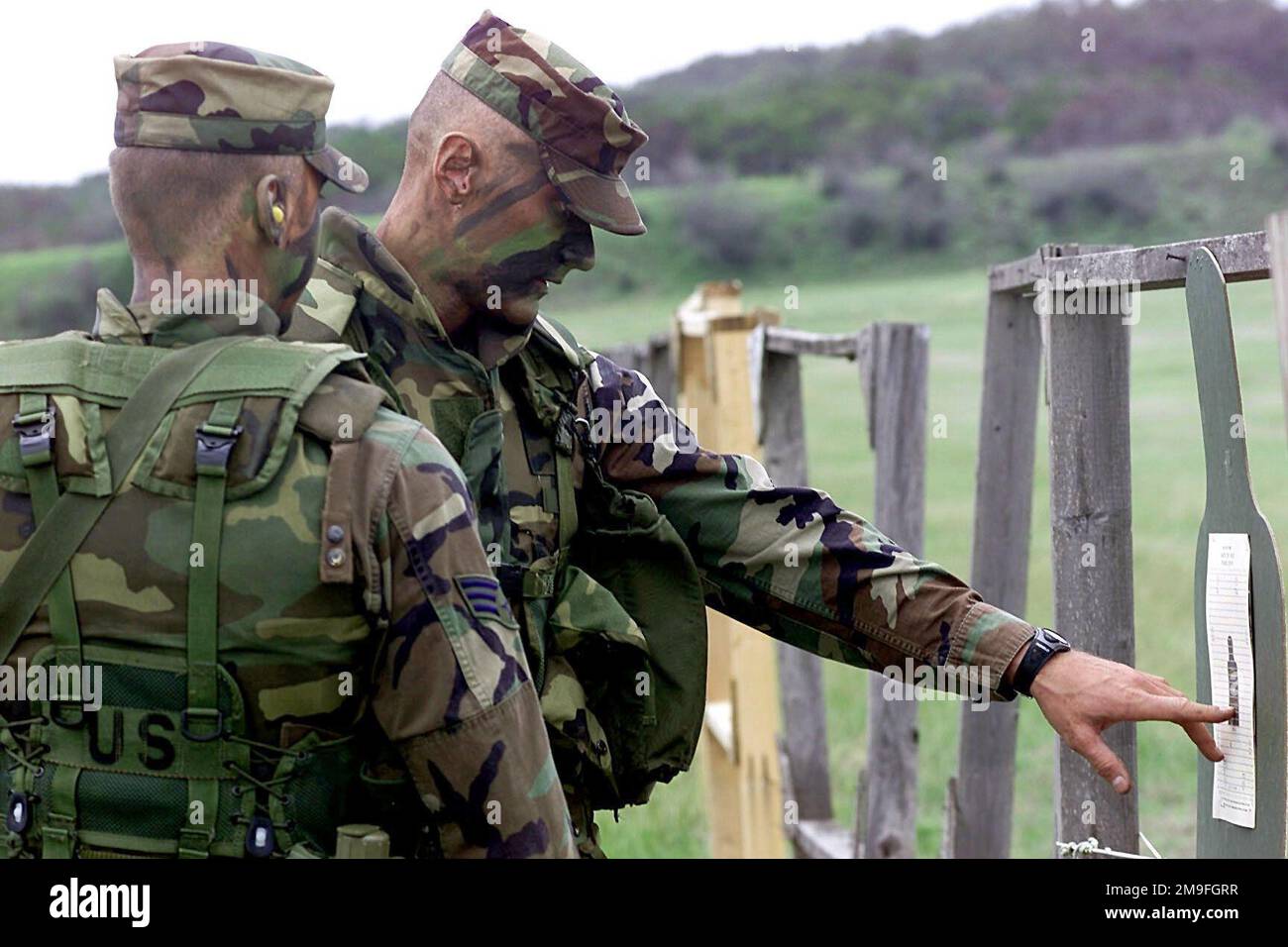 US Air Force STAFF Sergeant Tim Sullivan points out his hits on a ...