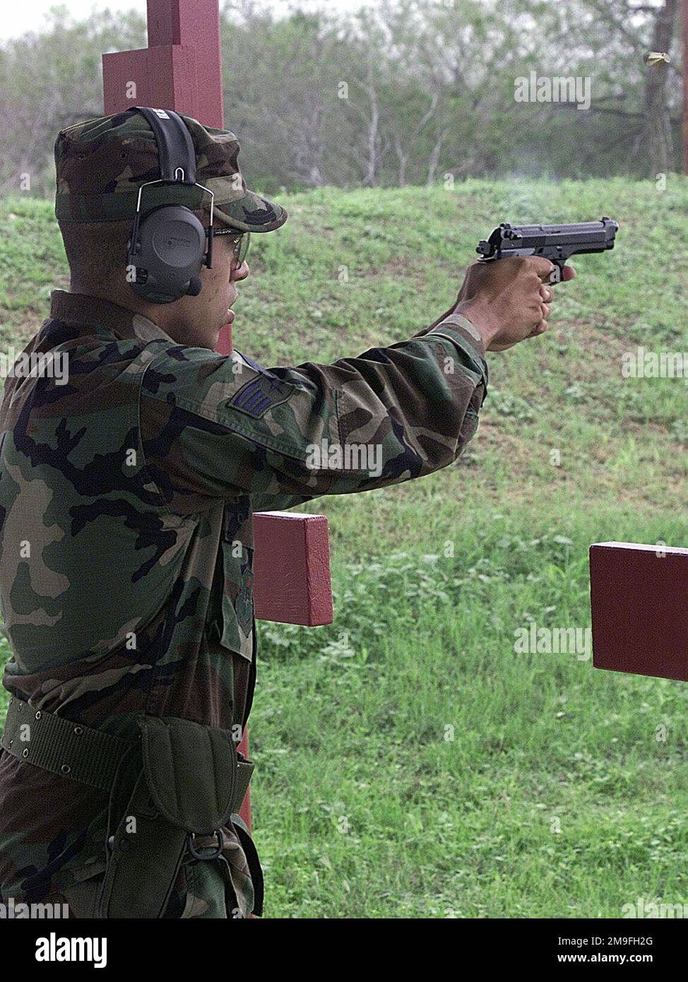 US Air Force SENIOR AIRMAN Gabe Gonzalez fires a Beretta M-9 pistol ...