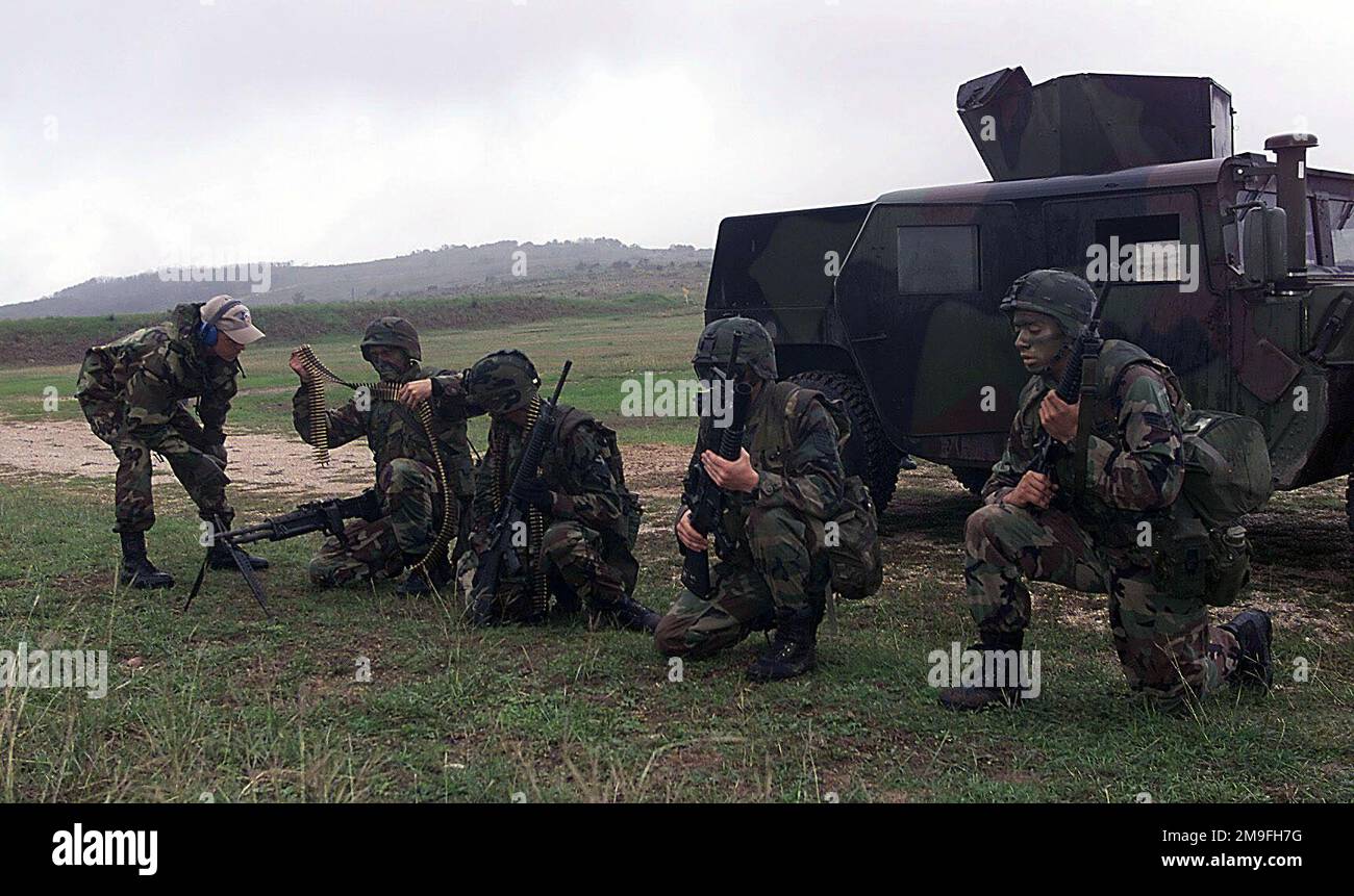 An instructor watches the 7.62mm M60 machine gunner from the US Air ...