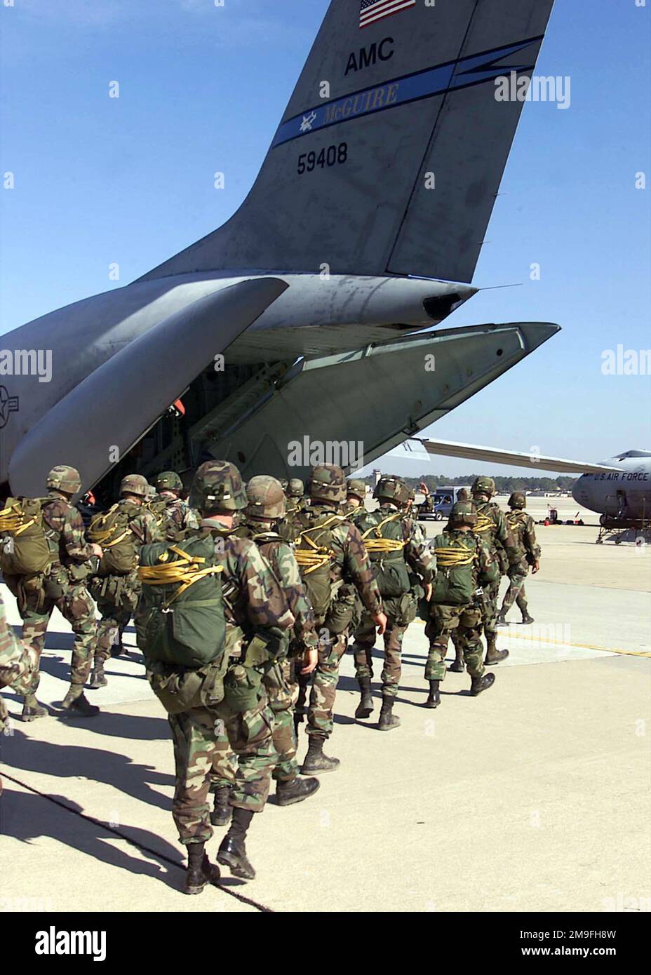 Members of the 82nd Airborne head to a McGuire Air Force Base C-141B ...