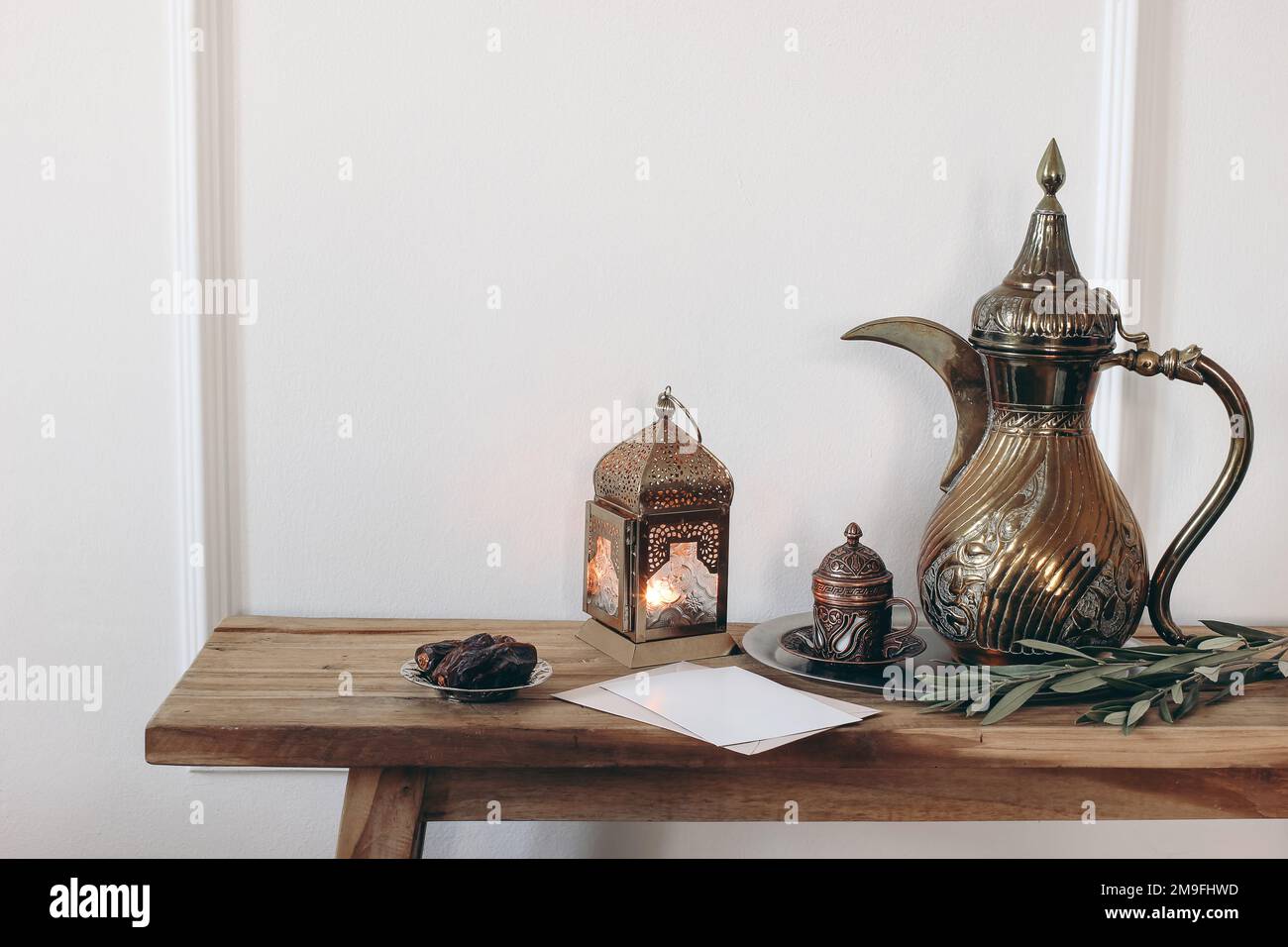 Ramadan Kareem still life. Ornamental burning lantern, cup and golden ...