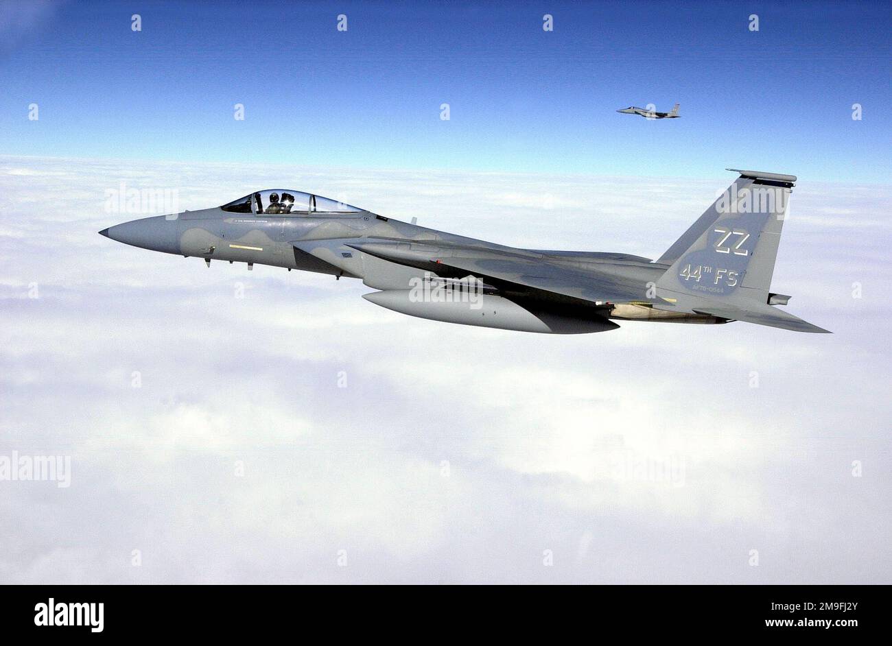 An air-to-air left side view of an F-15C Strike Eagle aircraft from the ...