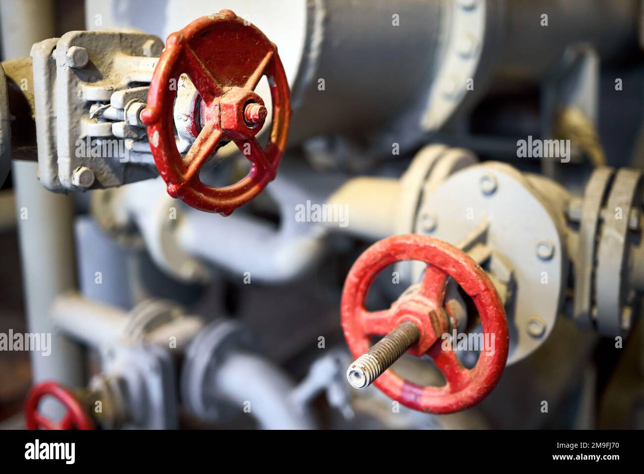 Two retro design industrial butterfly valves with red handwheels over ...